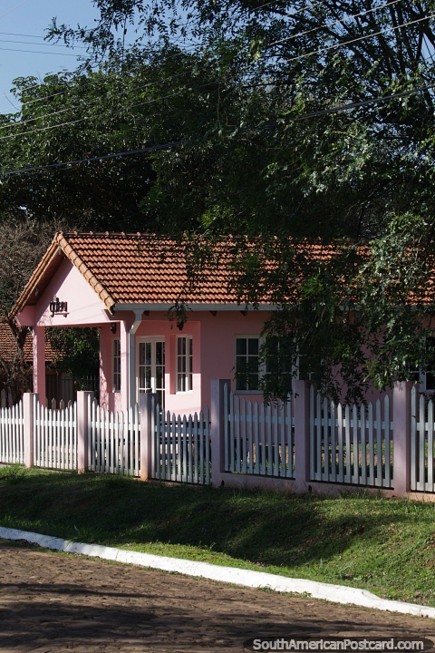 Pink building and fence, nice street in Carmen del Parana. Photo from ...